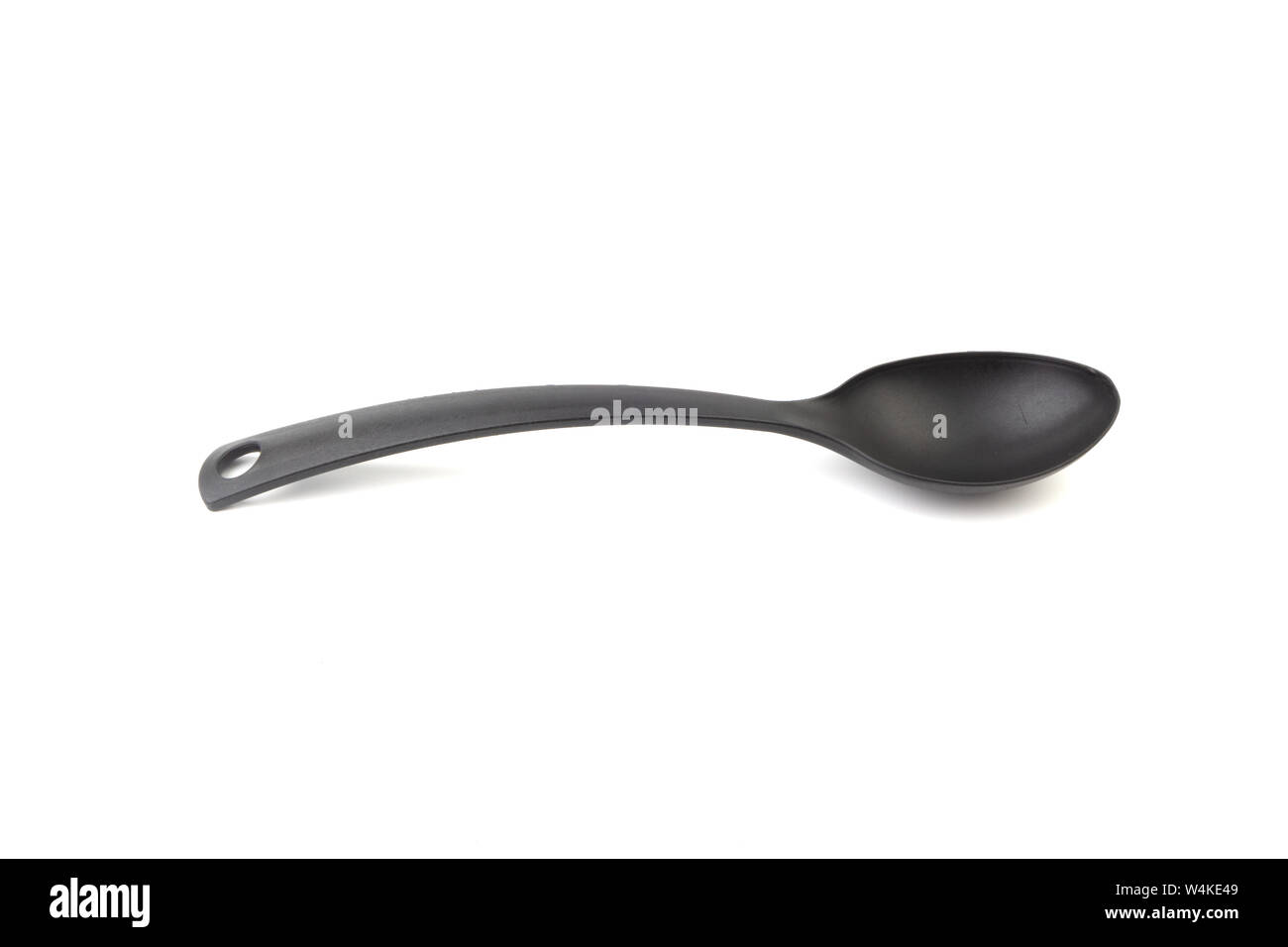 Black kitchen spoon utensils or kitchenware closeup isolated on white ...