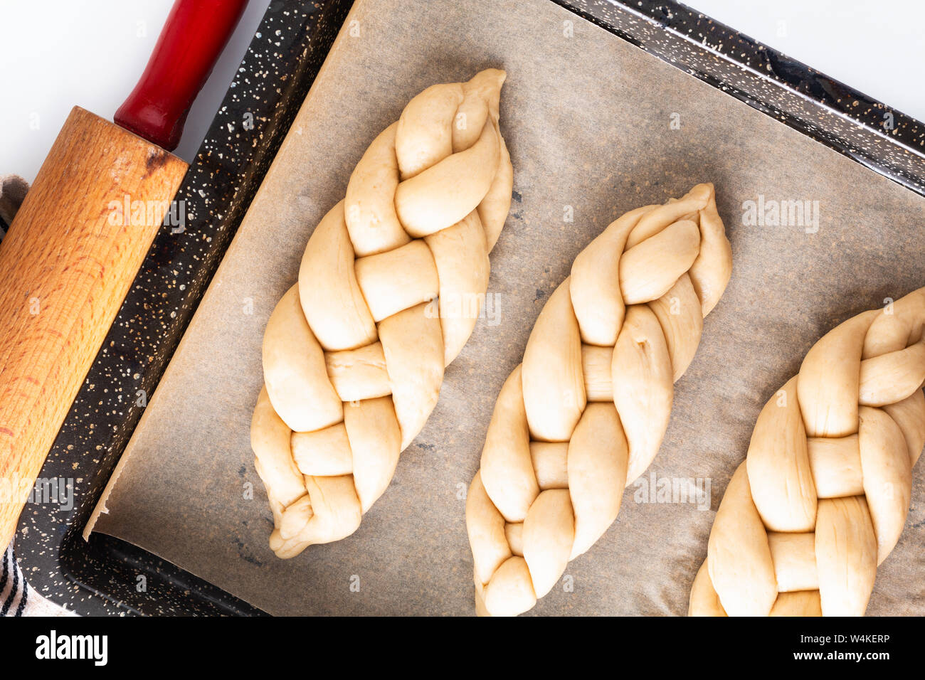 Homemade food concept process braiding bread braid challah dough on ...