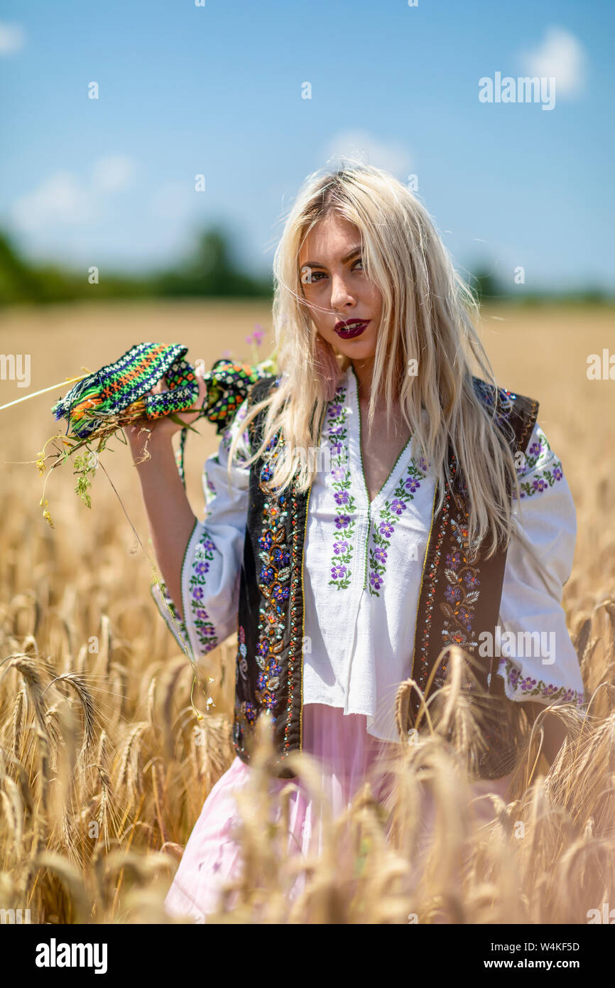 Beautiful girl in traditional costume in a wheat field Stock Photo - Alamy