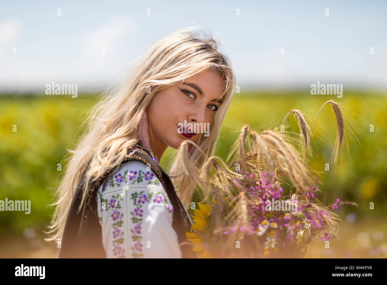 Beautiful girl in traditional costume in a wheat field Stock Photo - Alamy