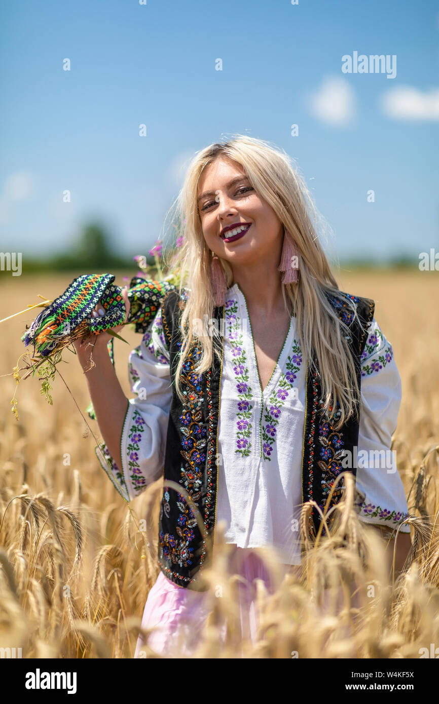 Beautiful girl in traditional costume in a wheat field Stock Photo - Alamy