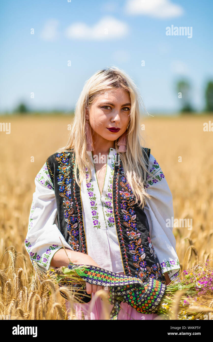 Beautiful girl in traditional costume in a wheat field Stock Photo - Alamy