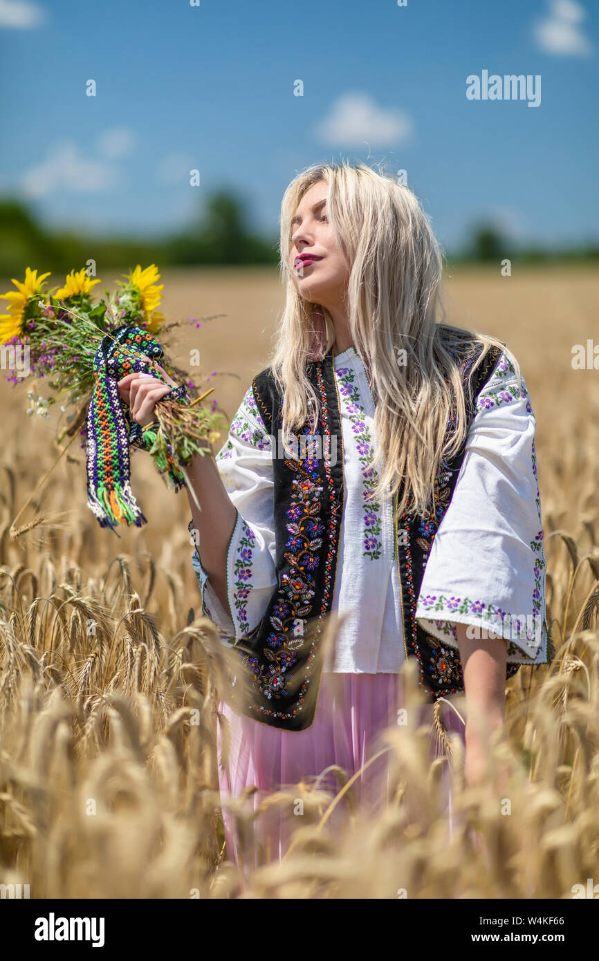 Beautiful girl in traditional costume in a wheat field Stock Photo - Alamy