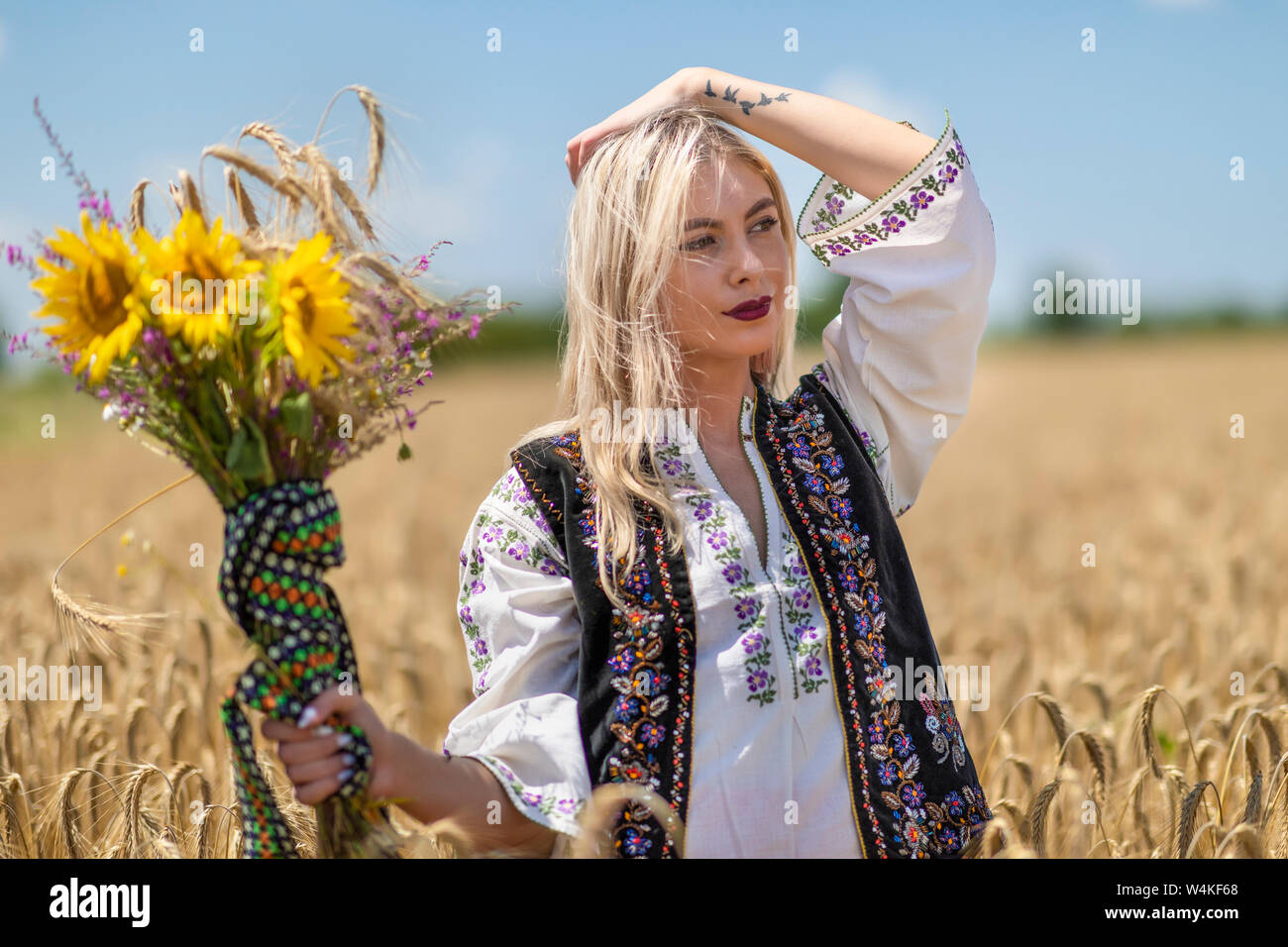 Beautiful girl in traditional costume in a wheat field Stock Photo - Alamy