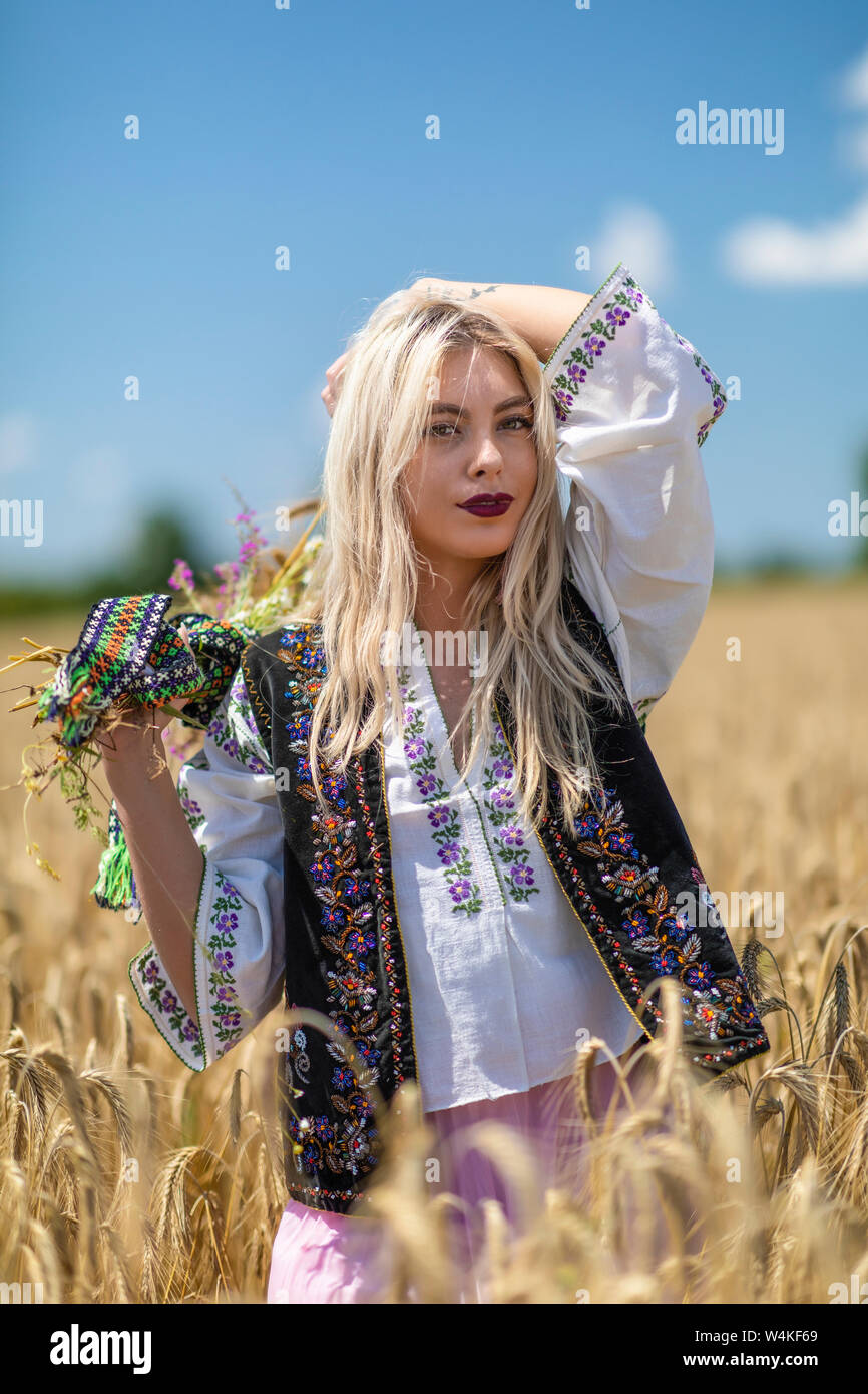 Beautiful girl in traditional costume in a wheat field Stock Photo - Alamy