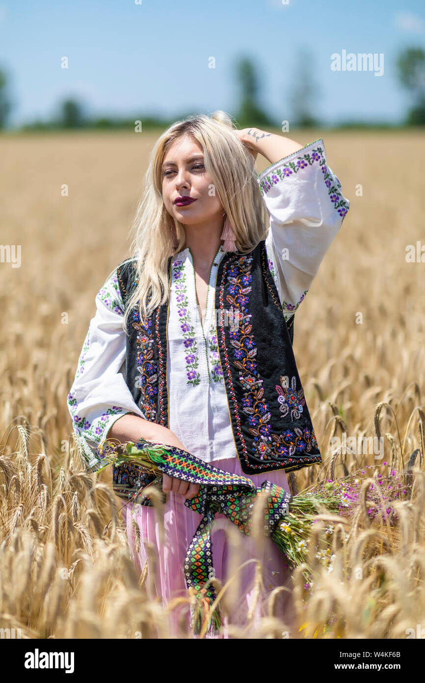 Beautiful girl in traditional costume in a wheat field Stock Photo - Alamy