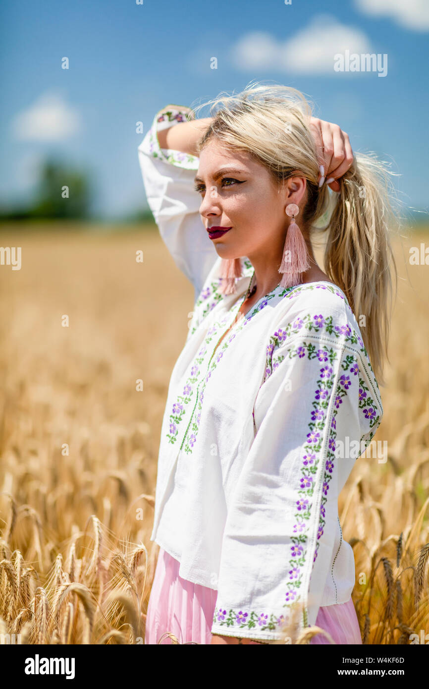 Beautiful girl in traditional costume in a wheat field Stock Photo - Alamy
