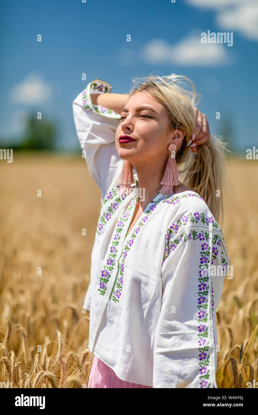 Beautiful girl in traditional costume in a wheat field Stock Photo - Alamy