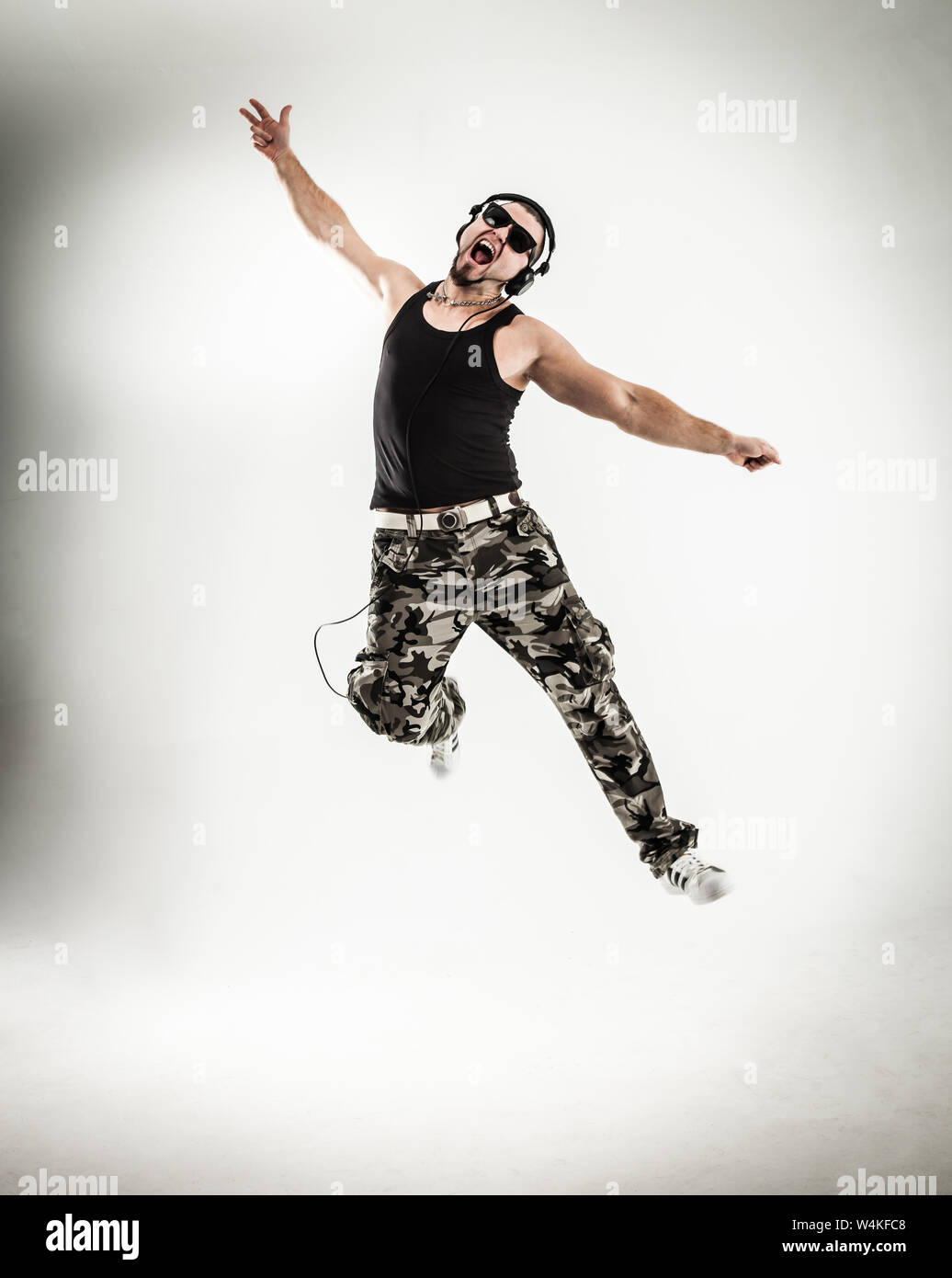 DJ - rapper in headphones takes the rap and break dancing dance on a ...