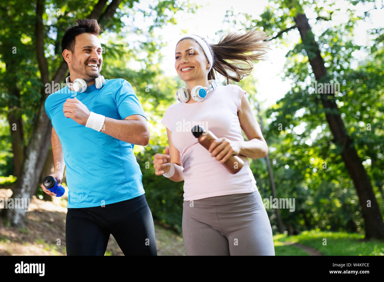 Happy couple running and exercising together outdoor Stock Photo - Alamy