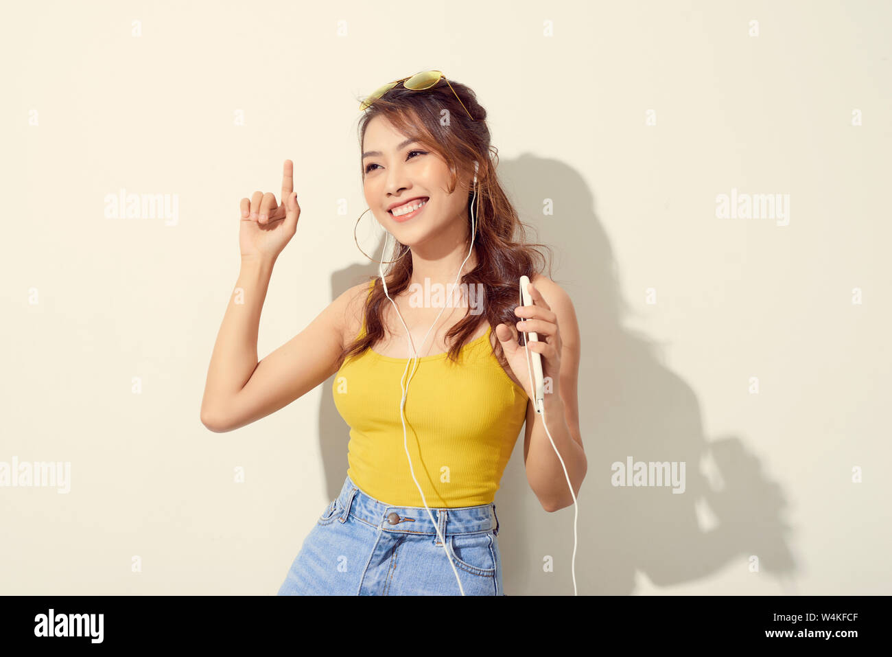 Summer lady. Beautiful asian girl singing and dancing while listening ...