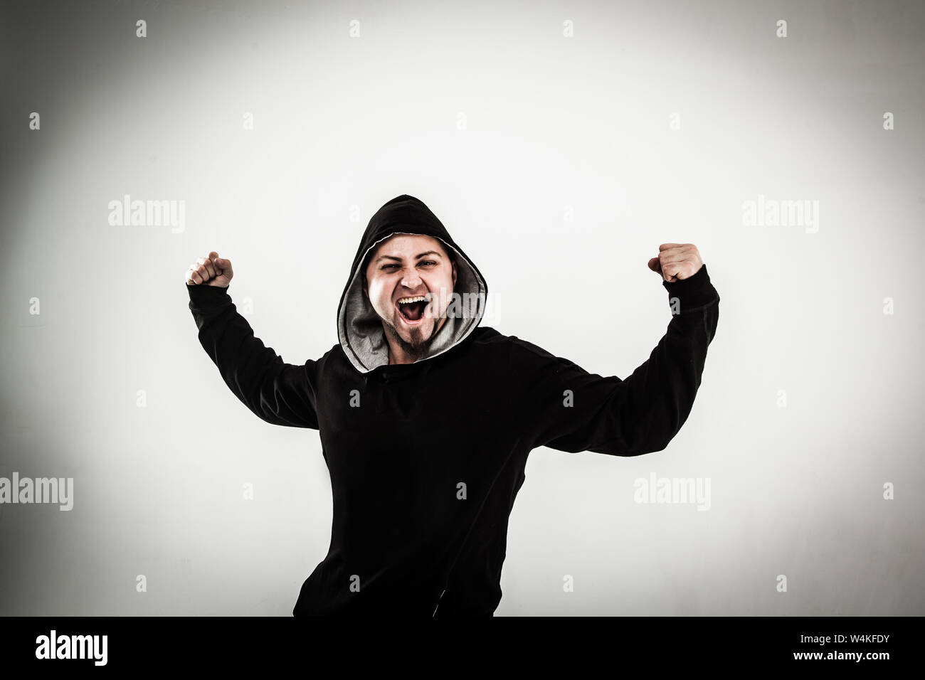 energetic guy rapper on a light background.the photo has a empty space ...
