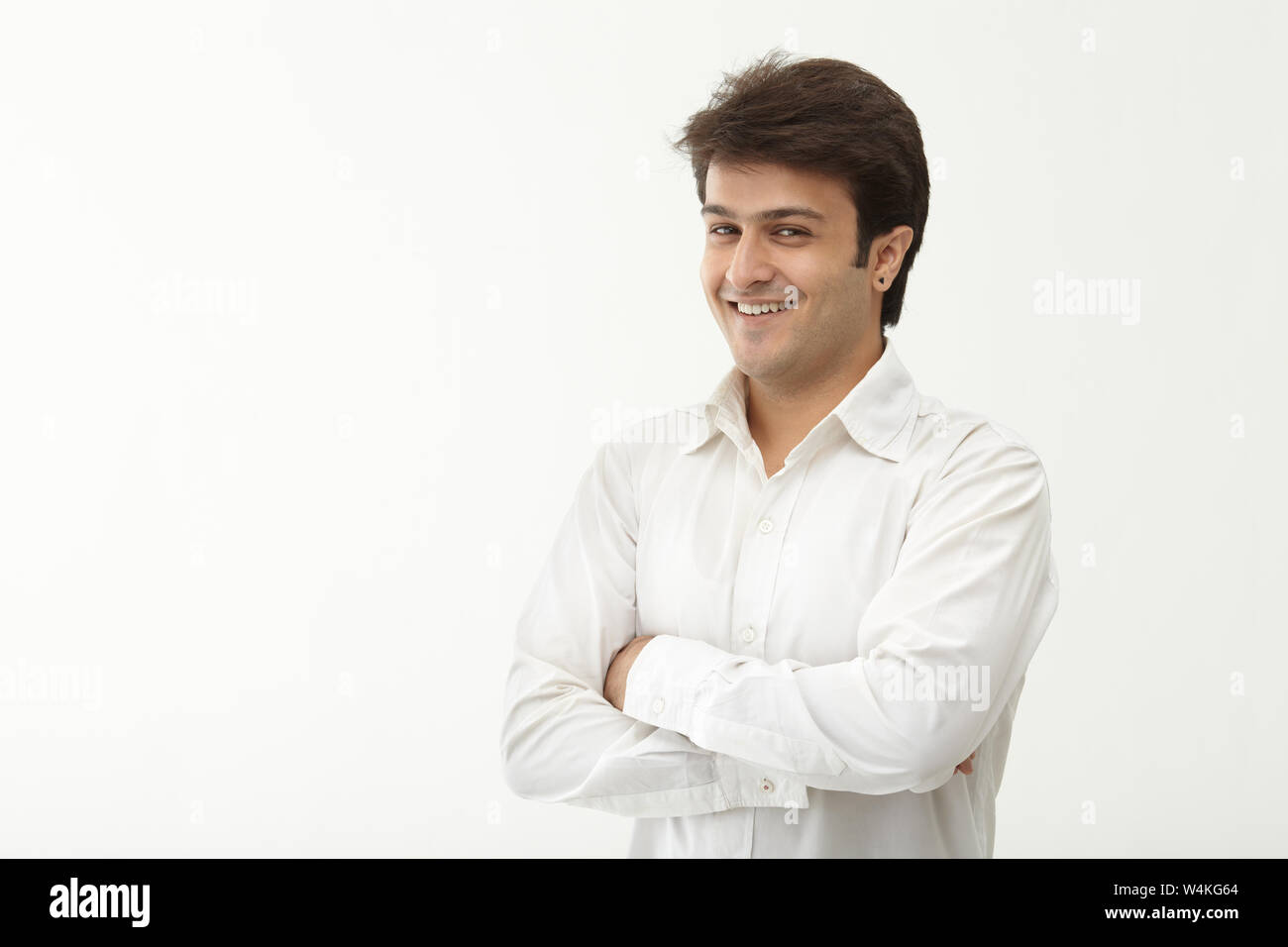 Man smiling with his arms crossed Stock Photo - Alamy