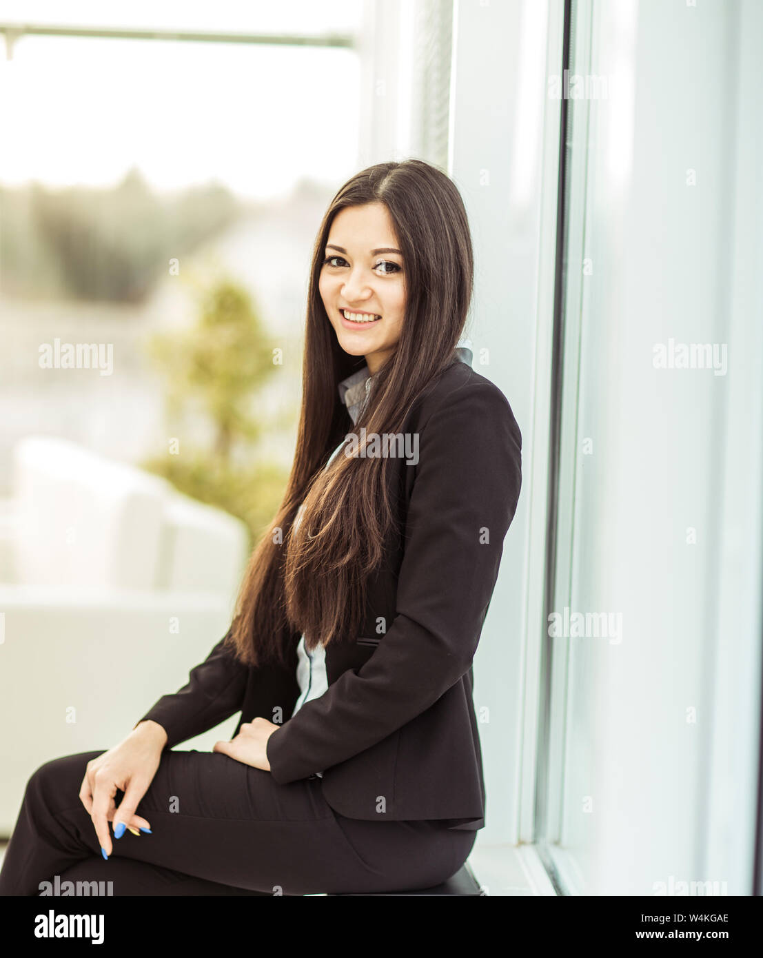 young prospective female employee on the background of a large window ...