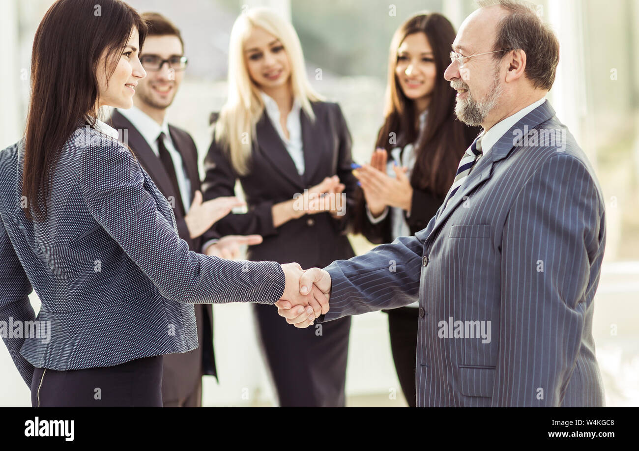 handshake of business partners after signing the contract, against the ...
