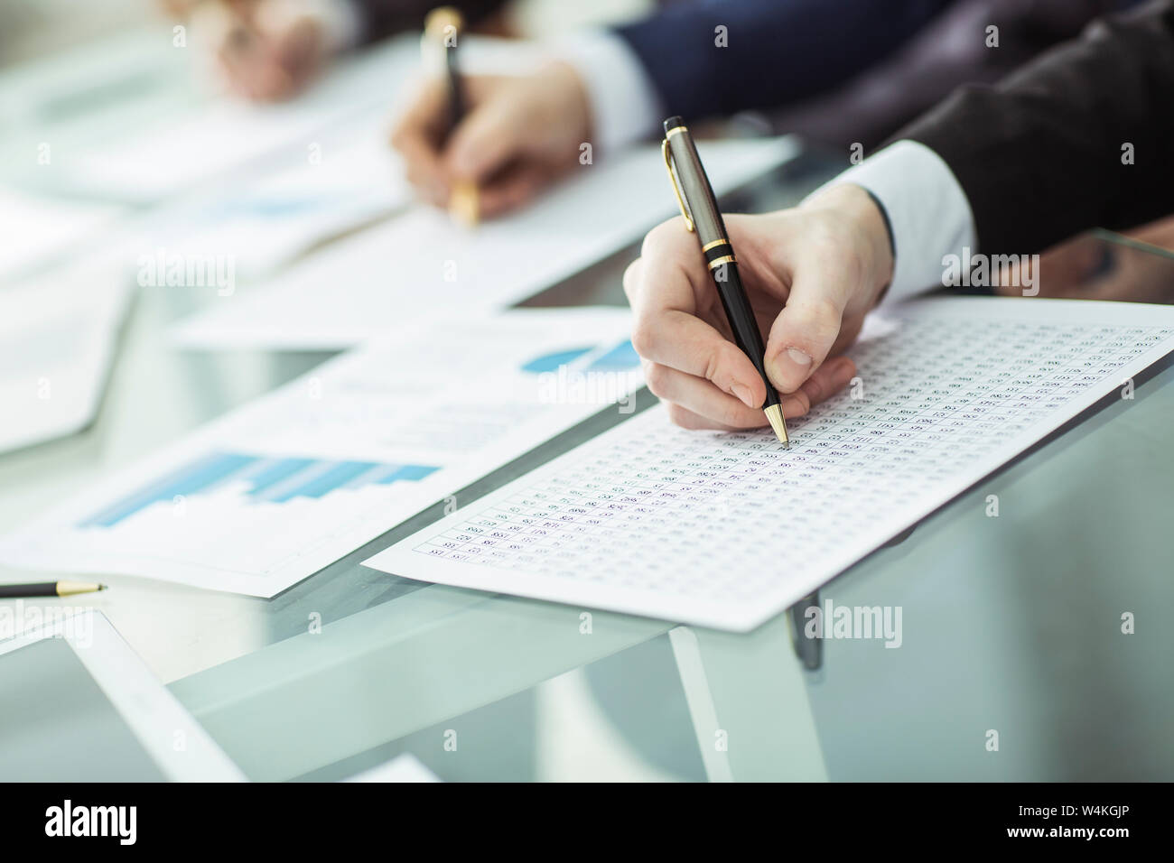 closeup: hands business team that works with financial schemes behind a ...
