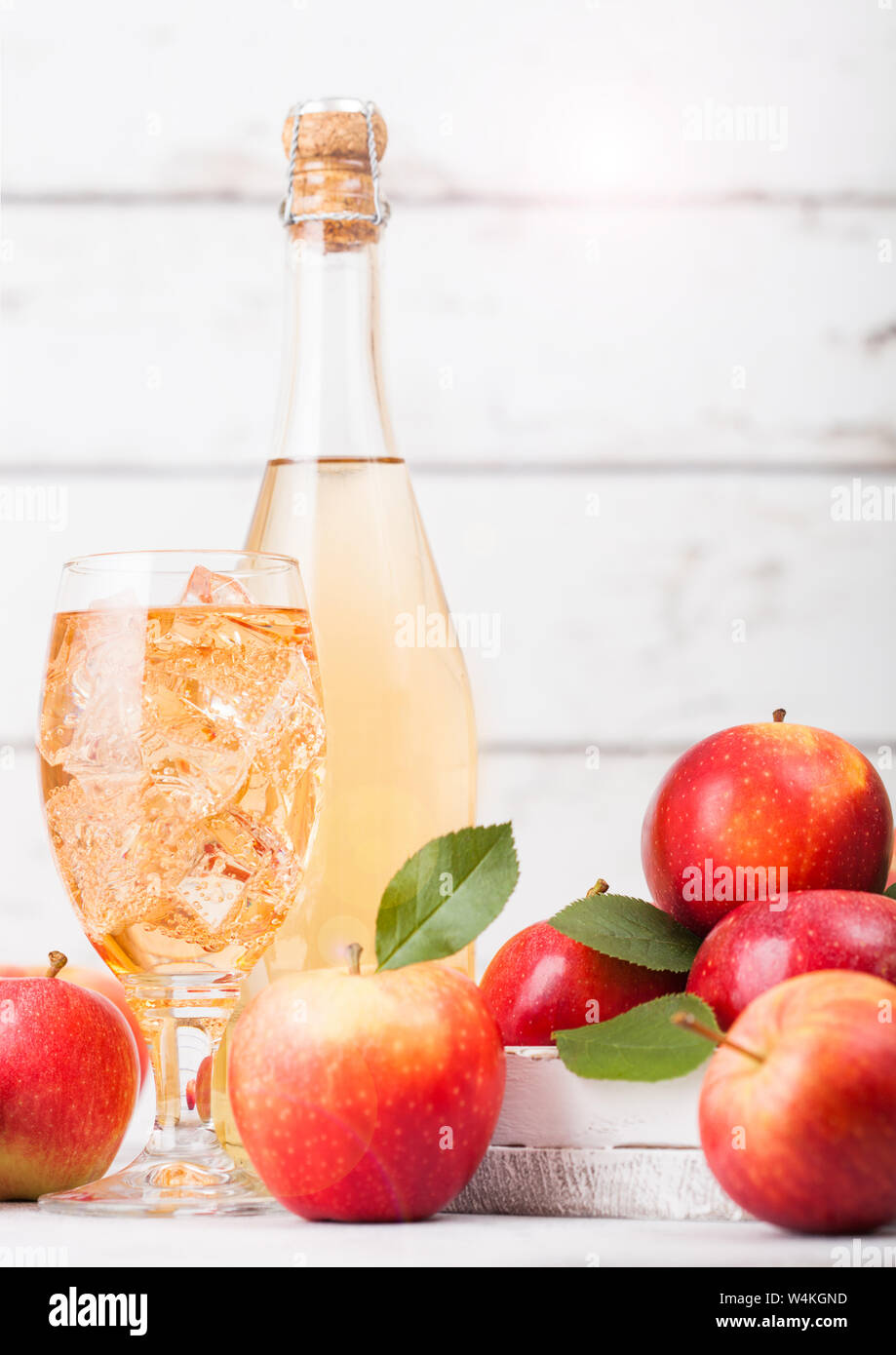 Bottle and glass of homemade organic apple cider with fresh apples in ...