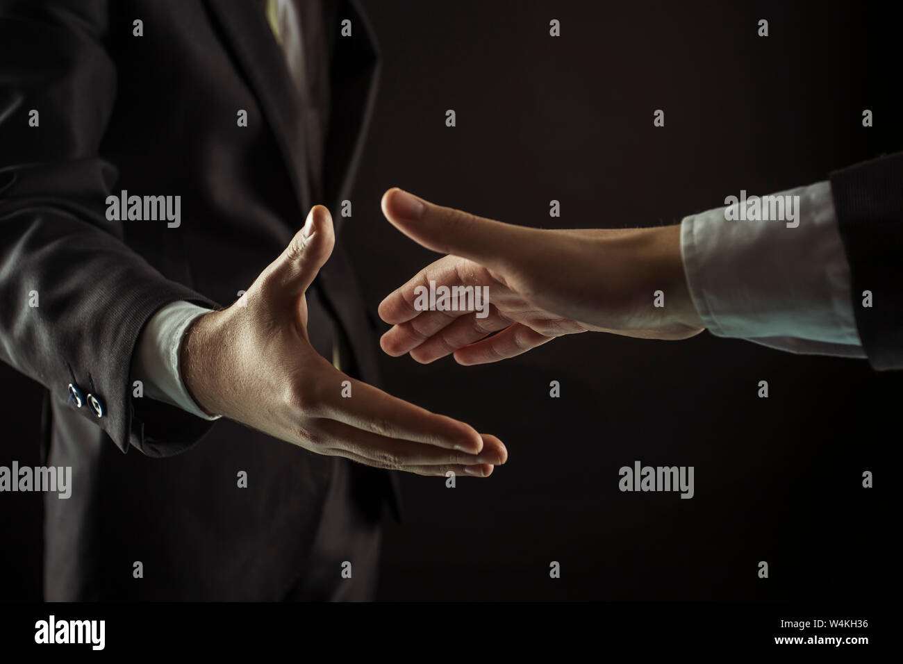 closeup of two businessmen stretches his hand forward for a handshake ...