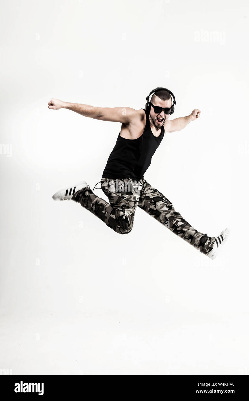 charismatic DJ - rapper with headphones on a white background.the photo ...