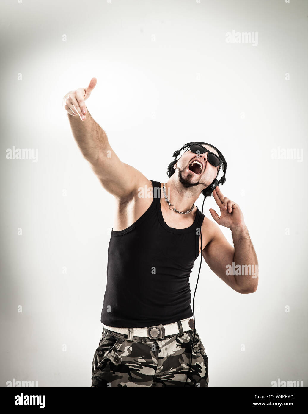 DJ - rapper in headphones takes the rap and break dancing dance on a ...