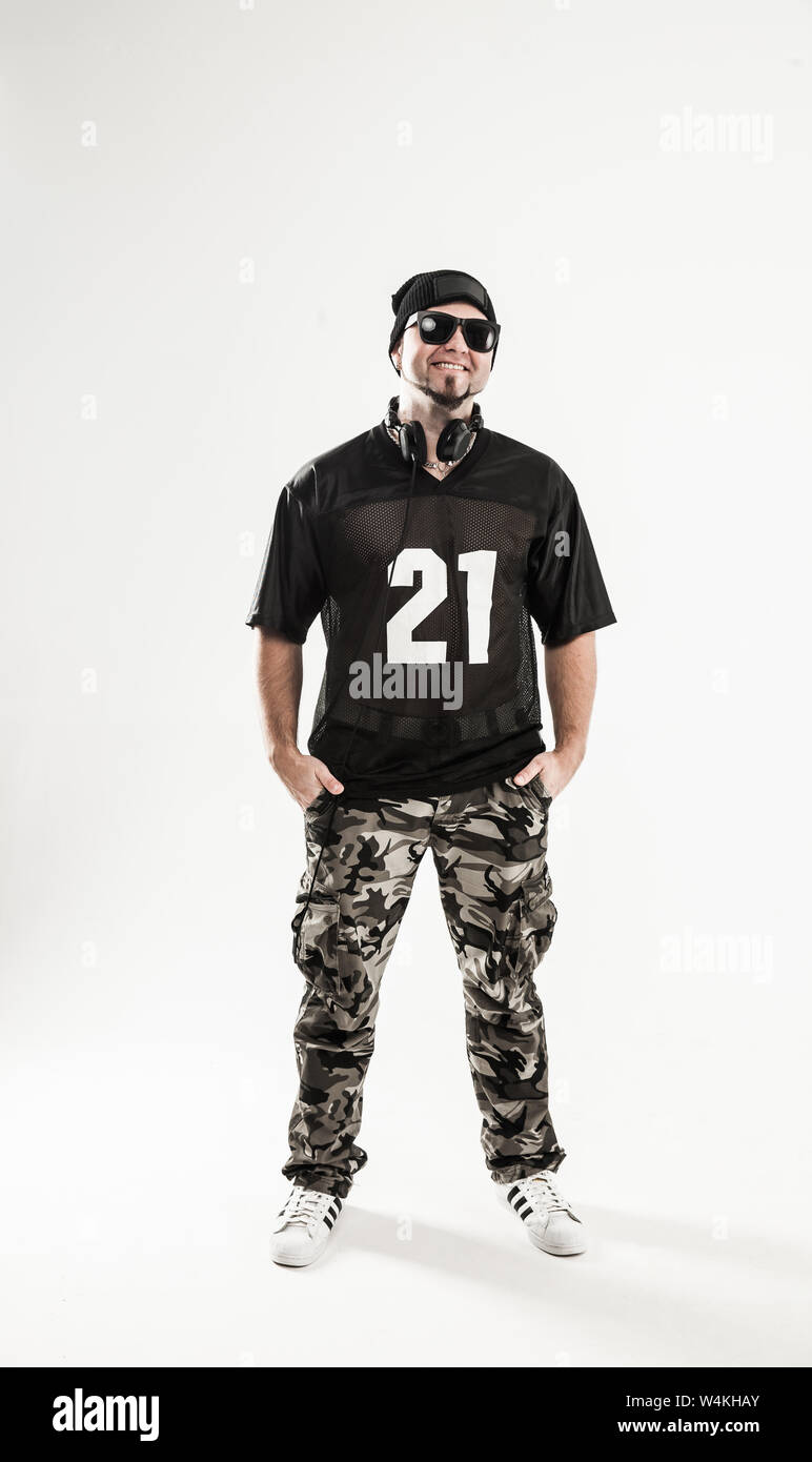 charismatic DJ - rapper with headphones on a light background.the photo ...