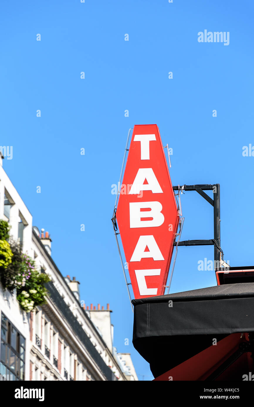 Red french tobacco shop sign with white lettering and modern building ...