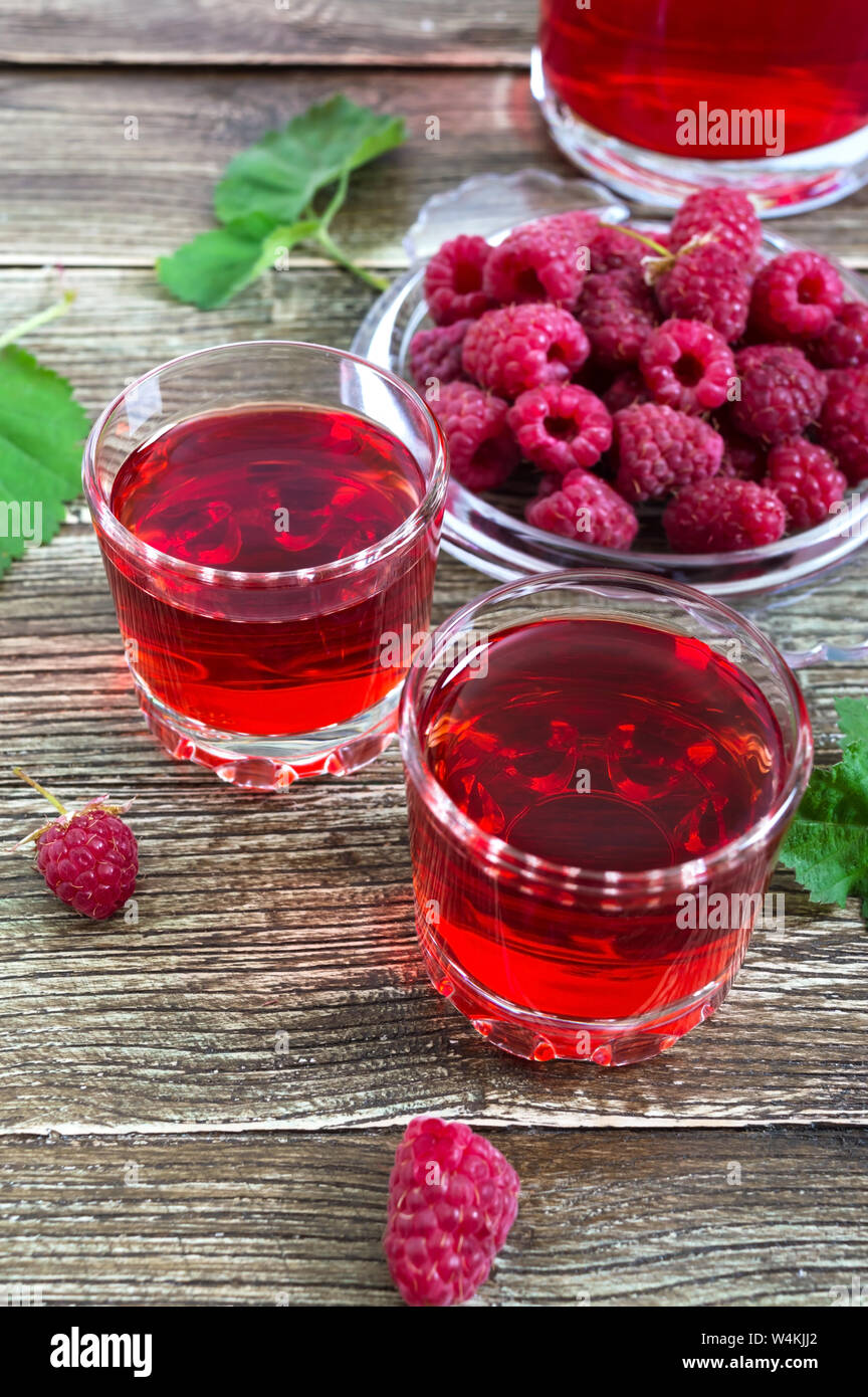 Raspberry liqueur in glass, fresh natural ripe organic berries and ...