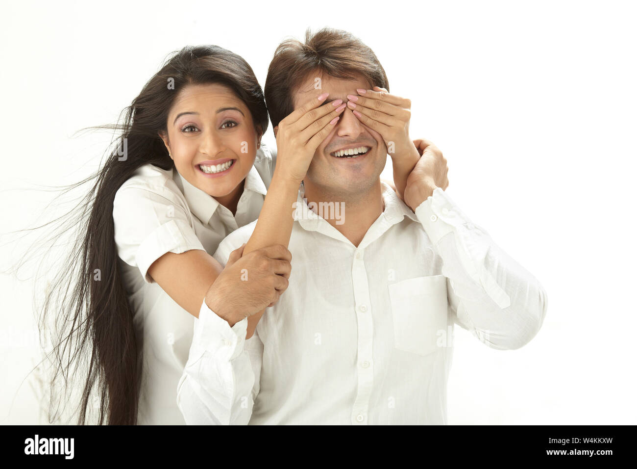 Woman covering a husband eyes from behind and smiling Stock Photo - Alamy