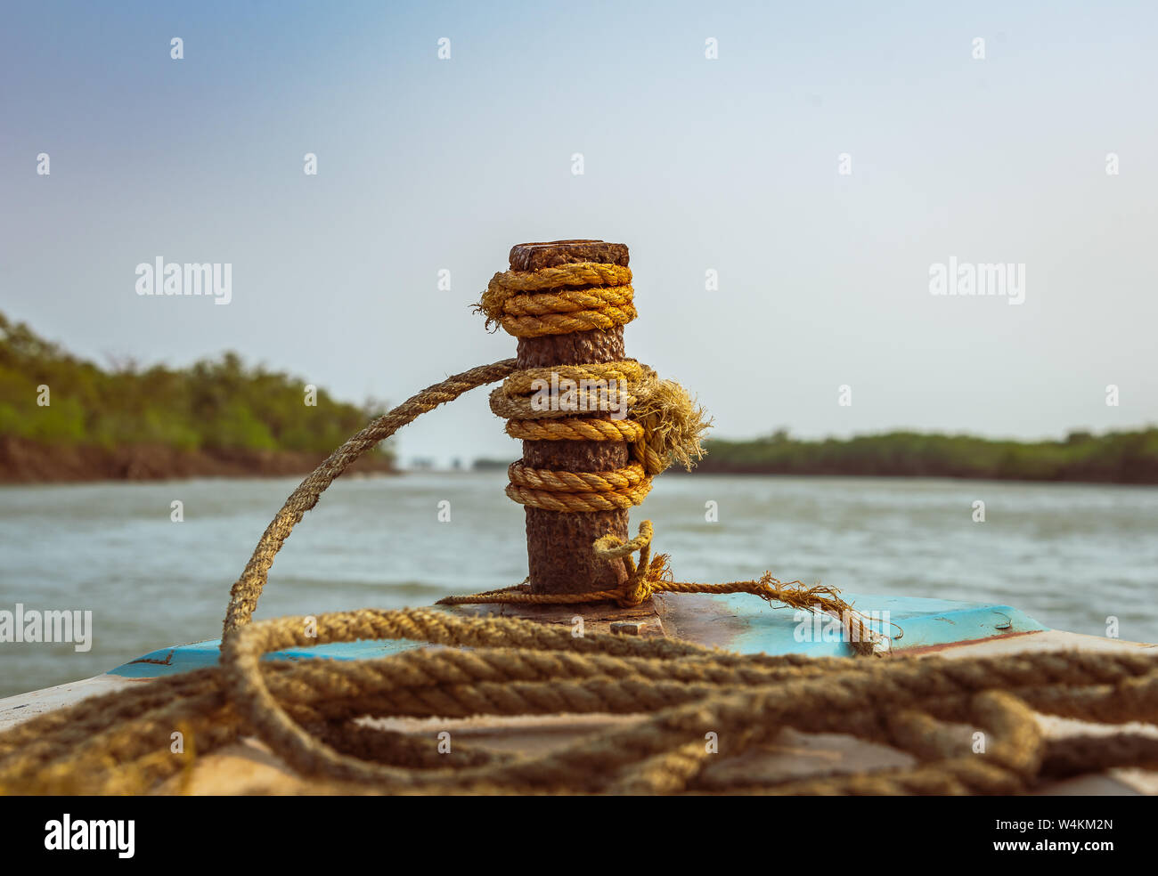 Nylon Rope with iron pillar in front of a boat. Selective Focus is used ...