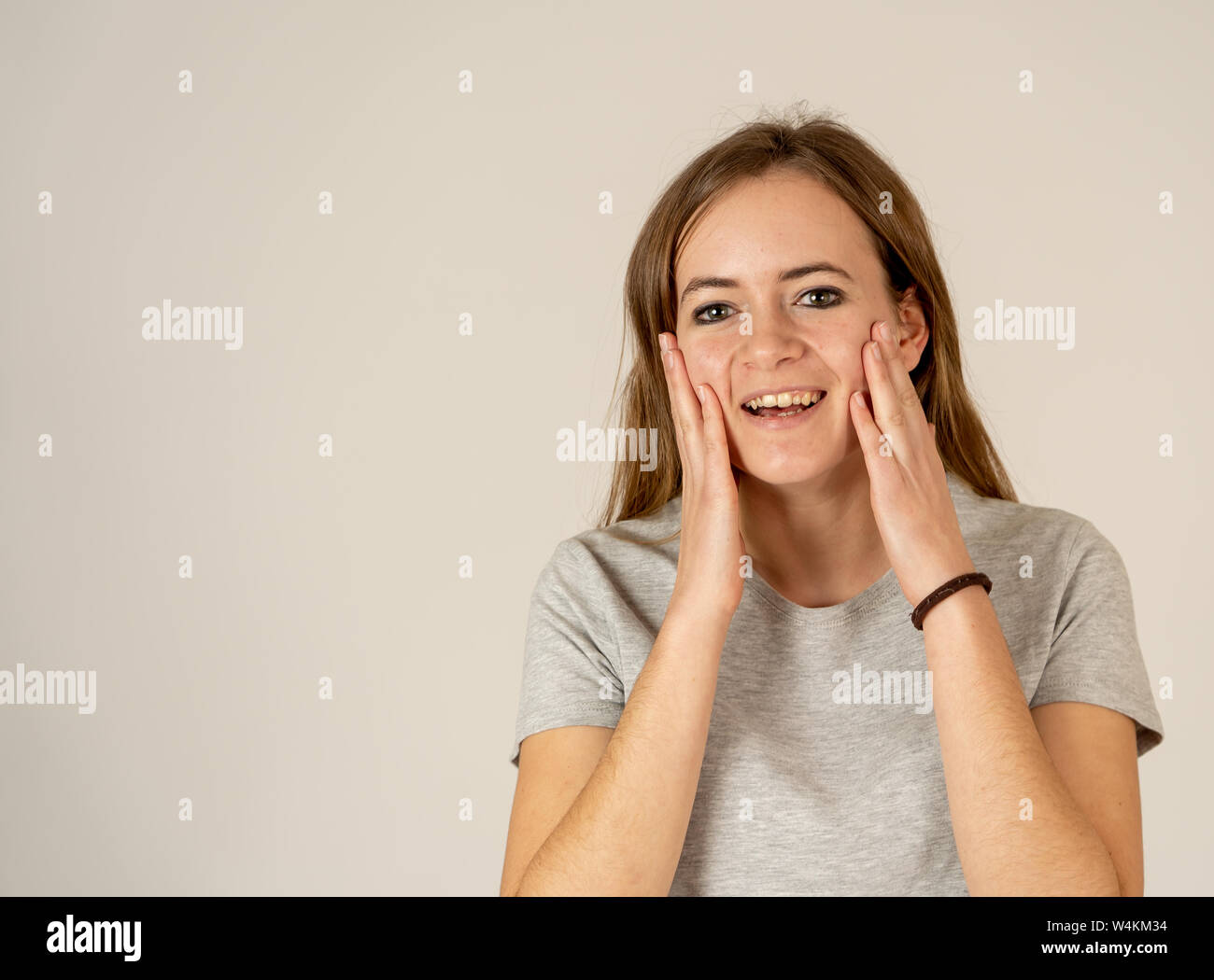 Young beautiful caucasian teenager girl happy, excited and shy ...