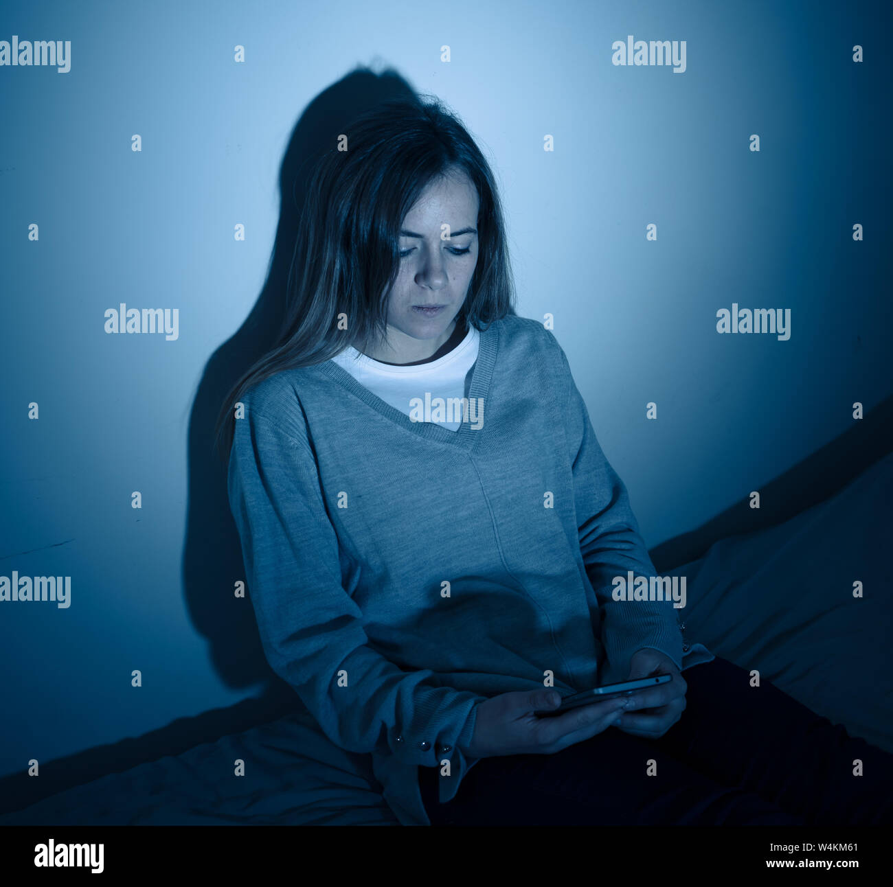 Young teenager girl suffering mobile cell phone addiction feeling ...