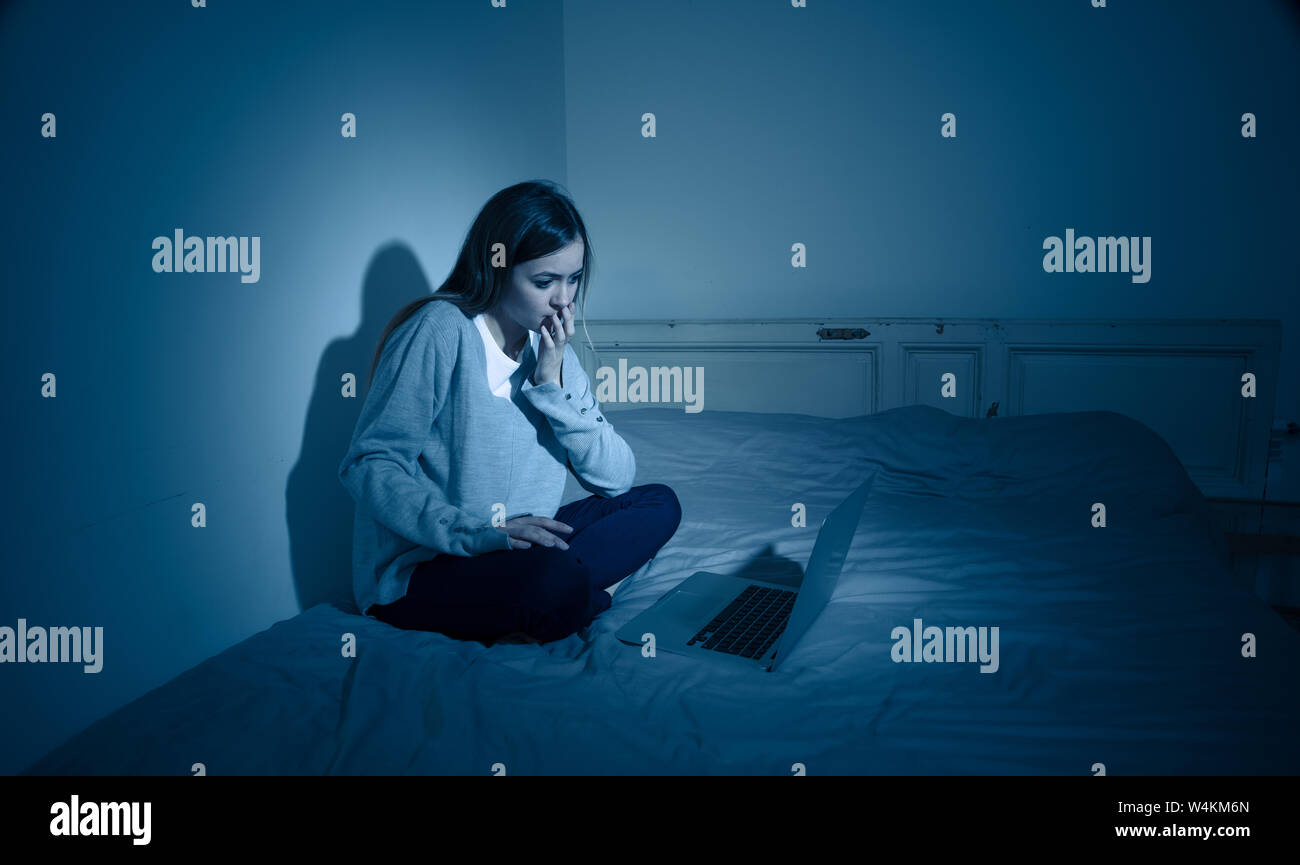 Scared and intimidated sad teenager bullied on line with laptop ...