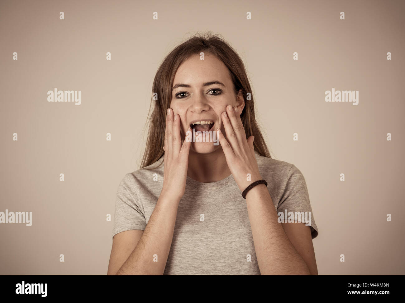 Portrait of beautiful shocked and shy teenager female having great ...