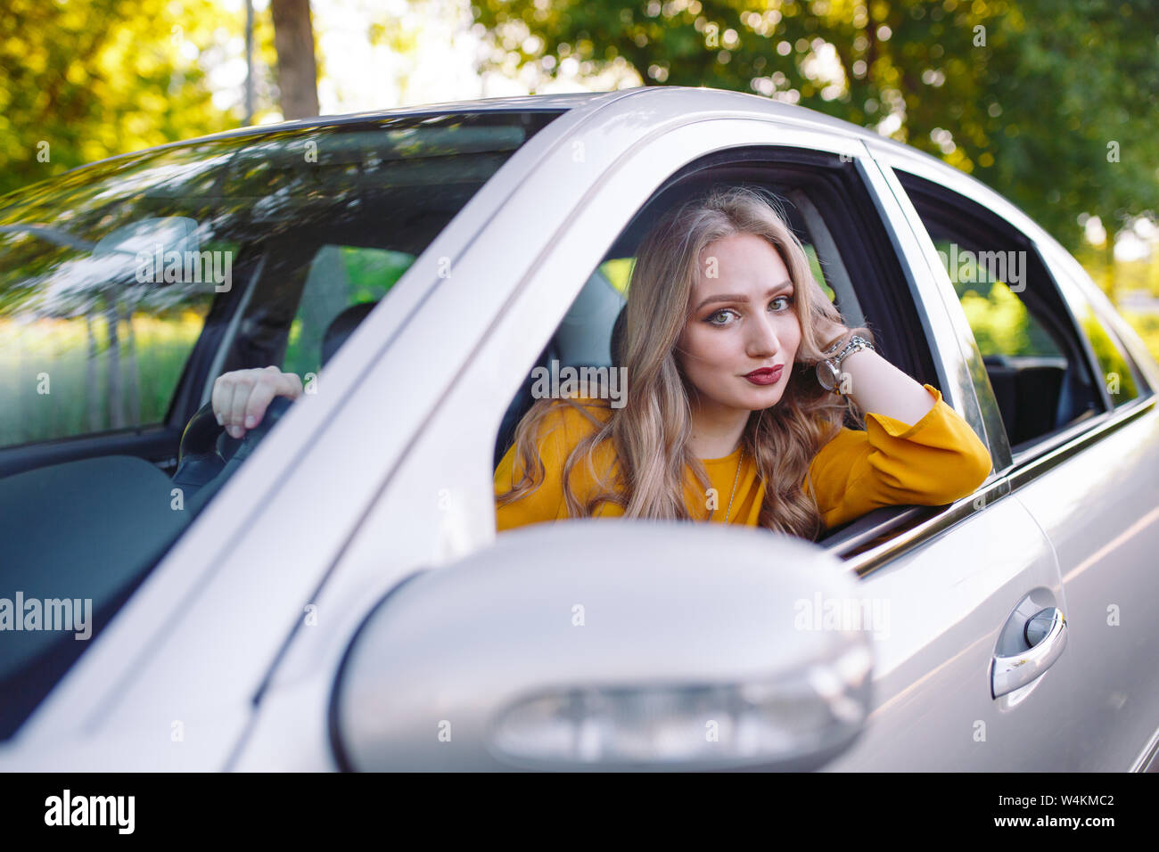 A young beautiful girl is driving a car Stock Photo - Alamy