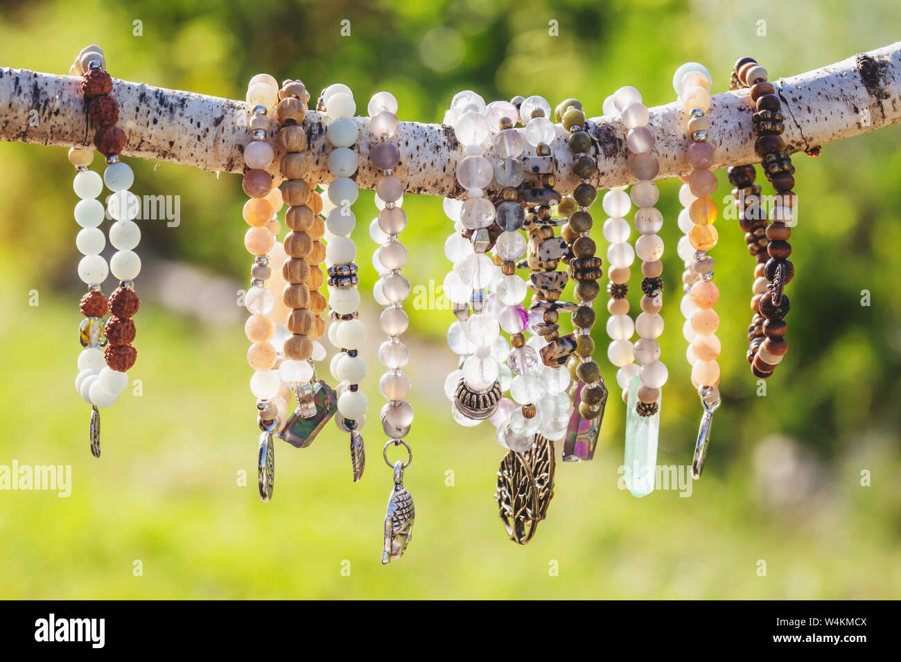 Collection of mineral stone beaded bracelets on natural outdoor ...