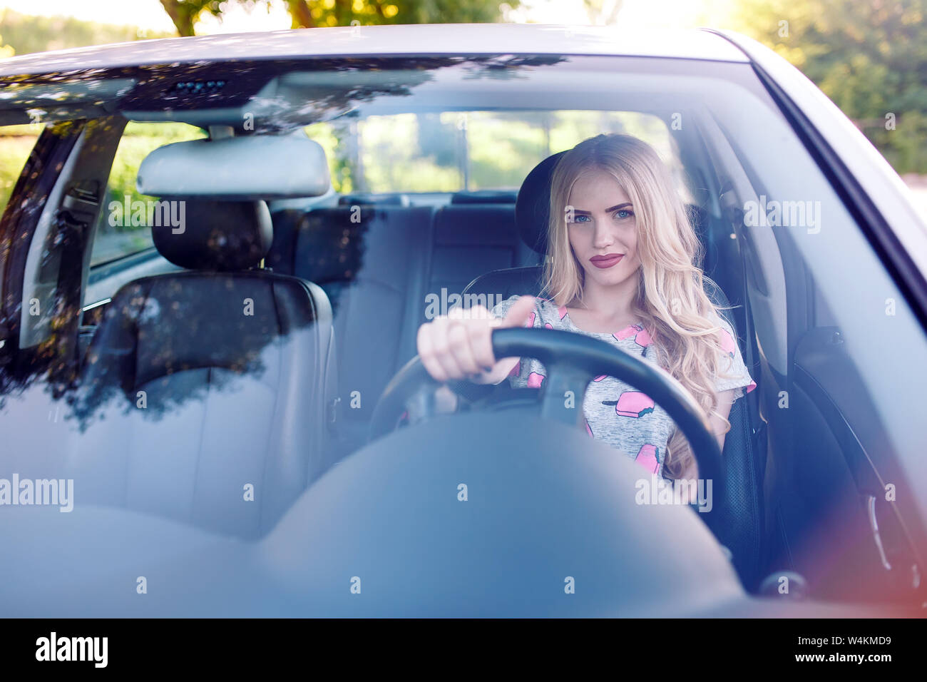 A young beautiful girl is driving a car Stock Photo - Alamy