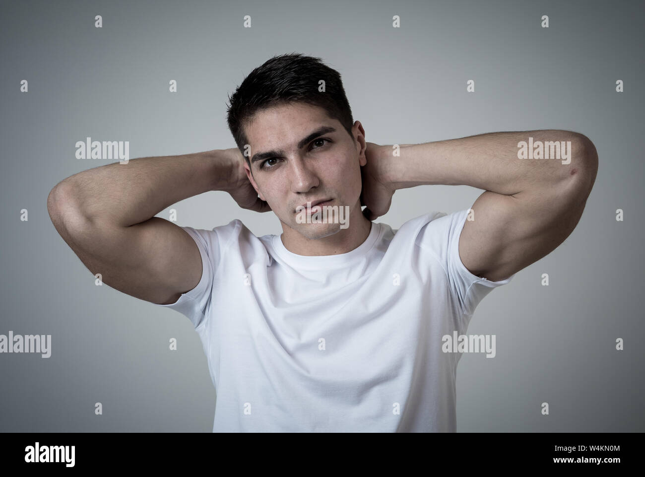 Young muscular fitness man touching and grabbing his neck and upper ...