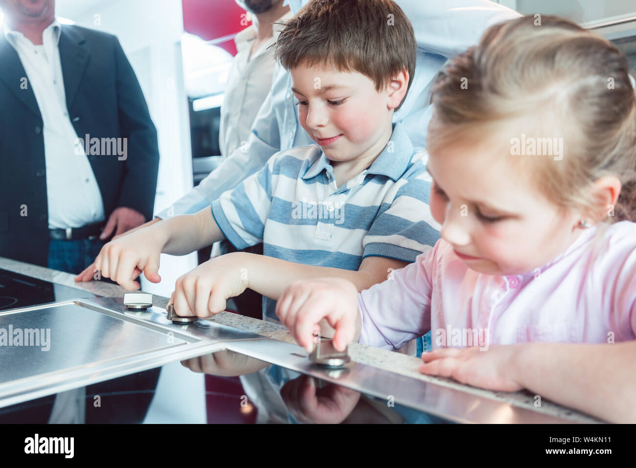 Children checking out the new kitchen their parents are about to buy ...