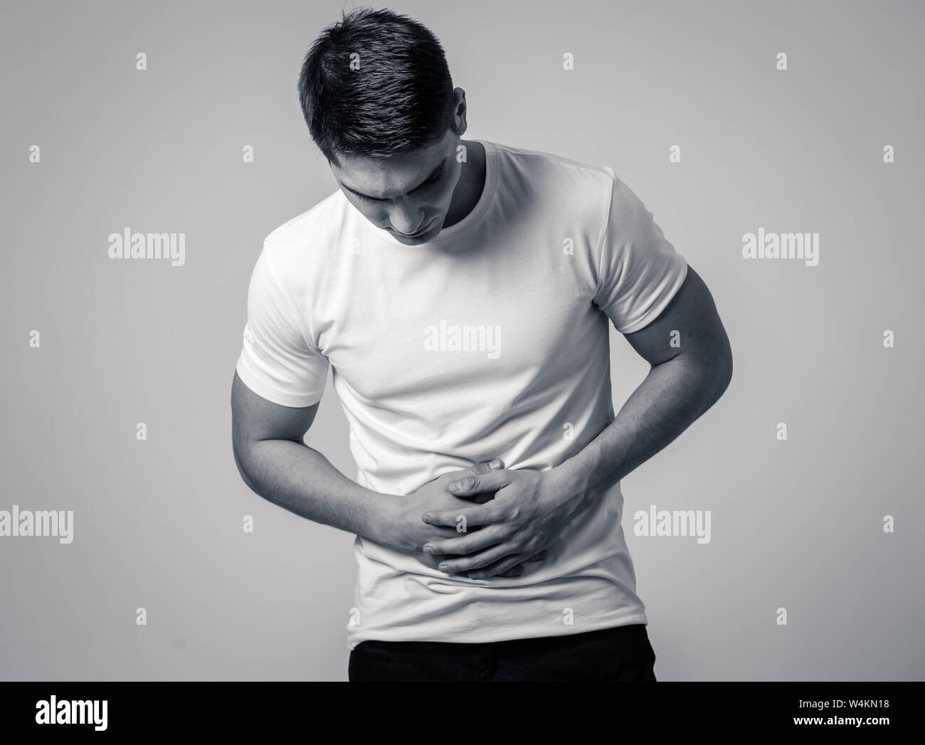 Young muscular fitness man holding his stomach suffering strong ...