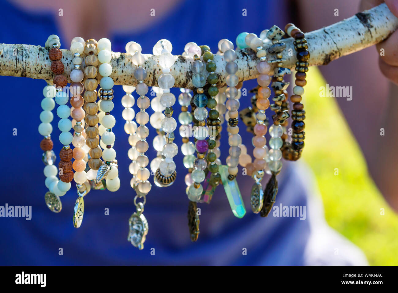 Collection of mineral stone beaded bracelets on natural outdoor ...