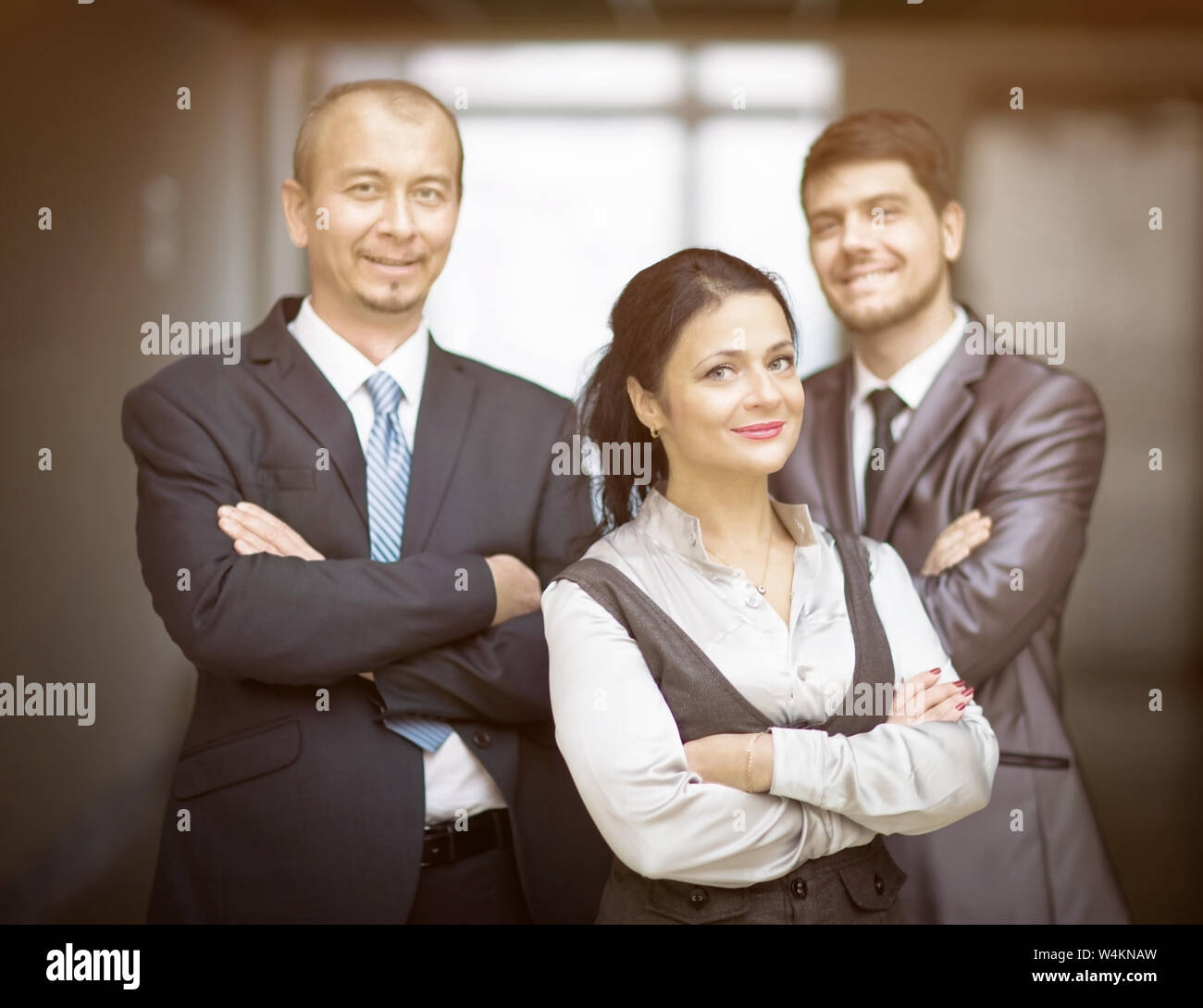 Smiling employees standing behind each other in the office Stock Photo ...
