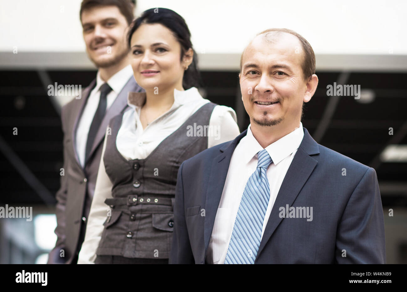 smiling employees standing around in the their manager Stock Photo - Alamy