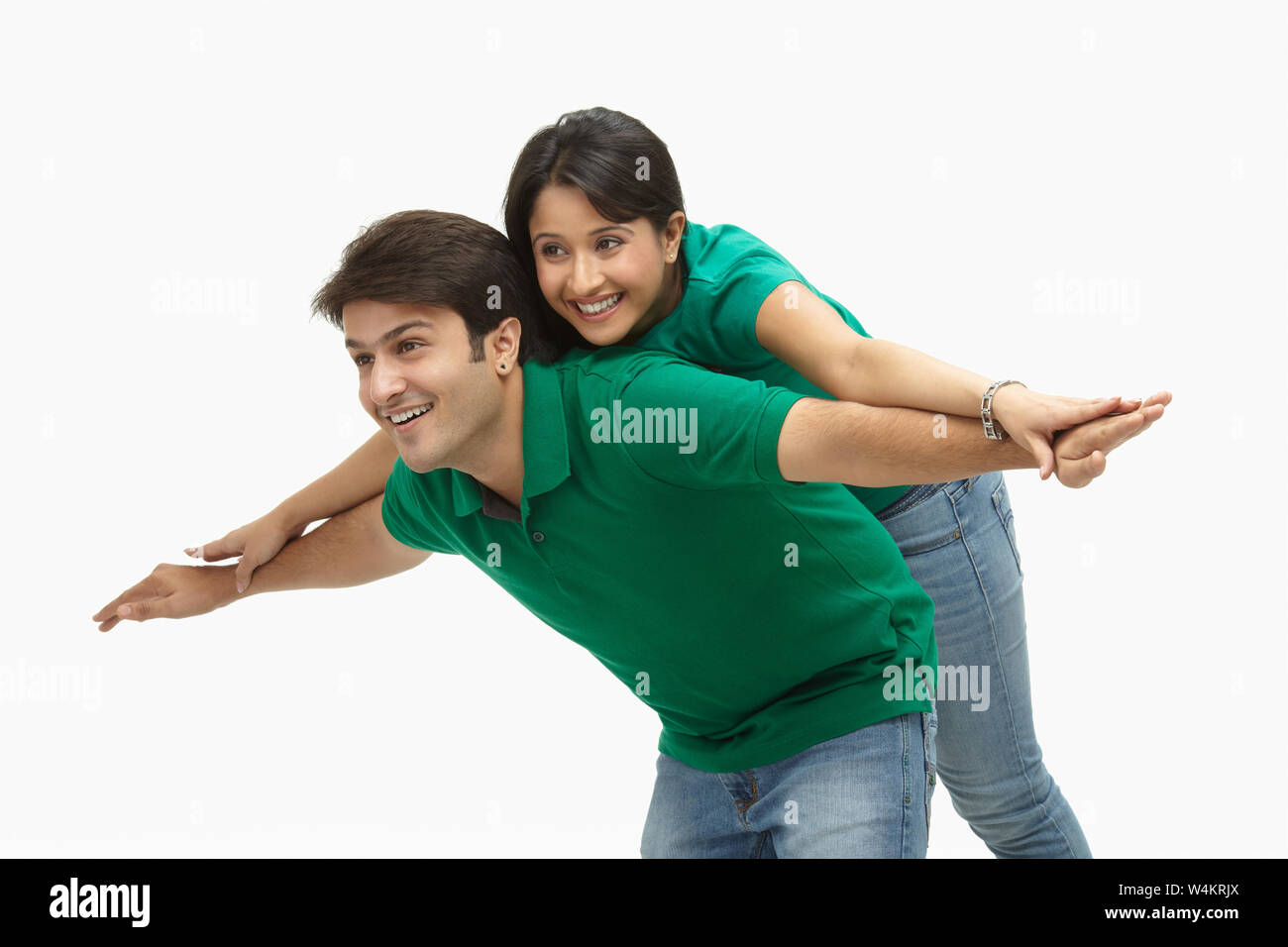 Couple pretending to fly Stock Photo - Alamy