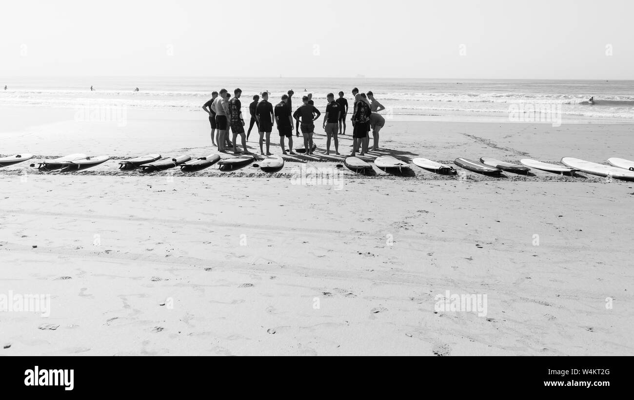 Surfing lessons on beach with surfboards with young men and surfer ...