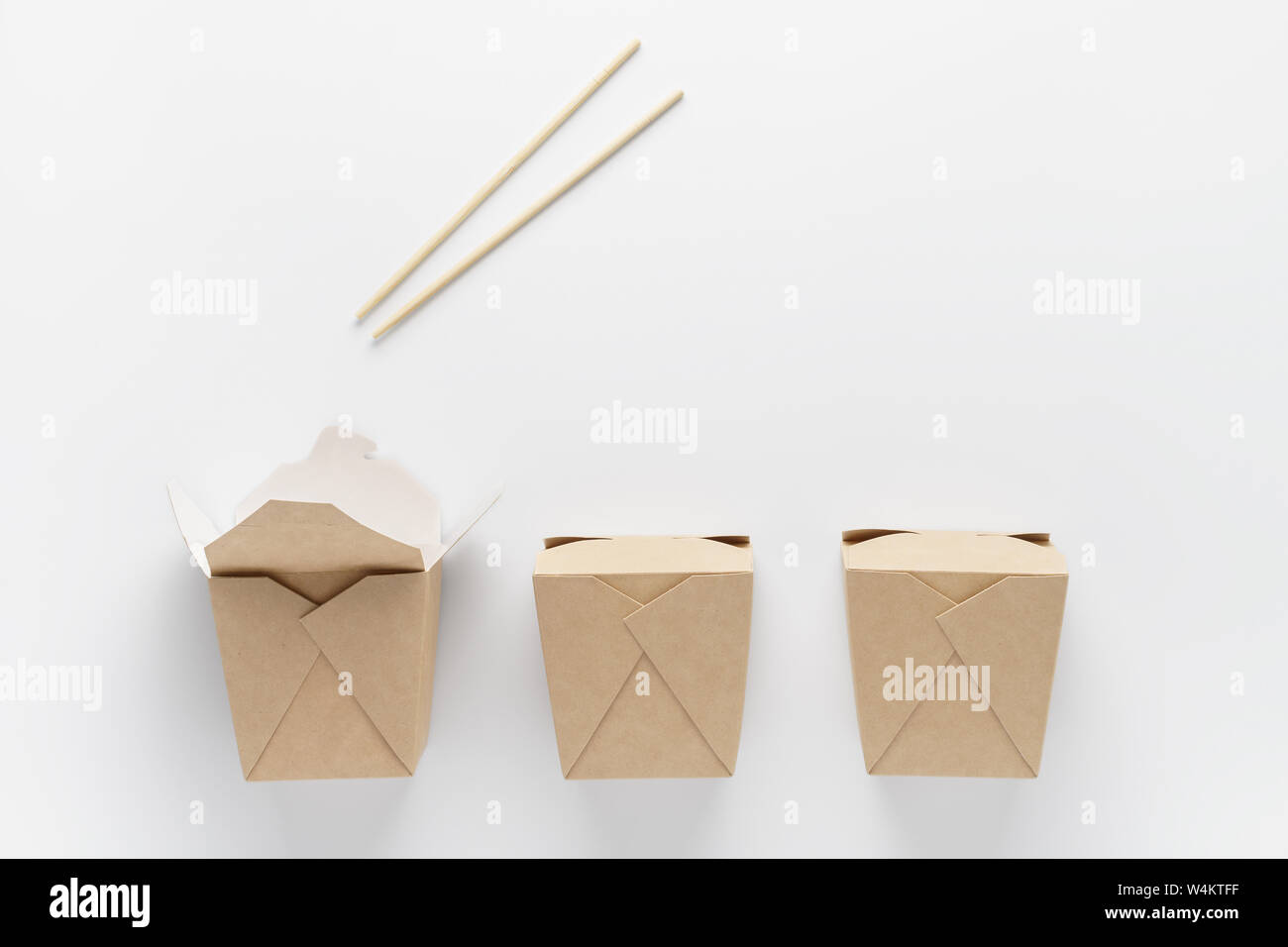 Cardboard container for takeaway food and chopsticks on white ...