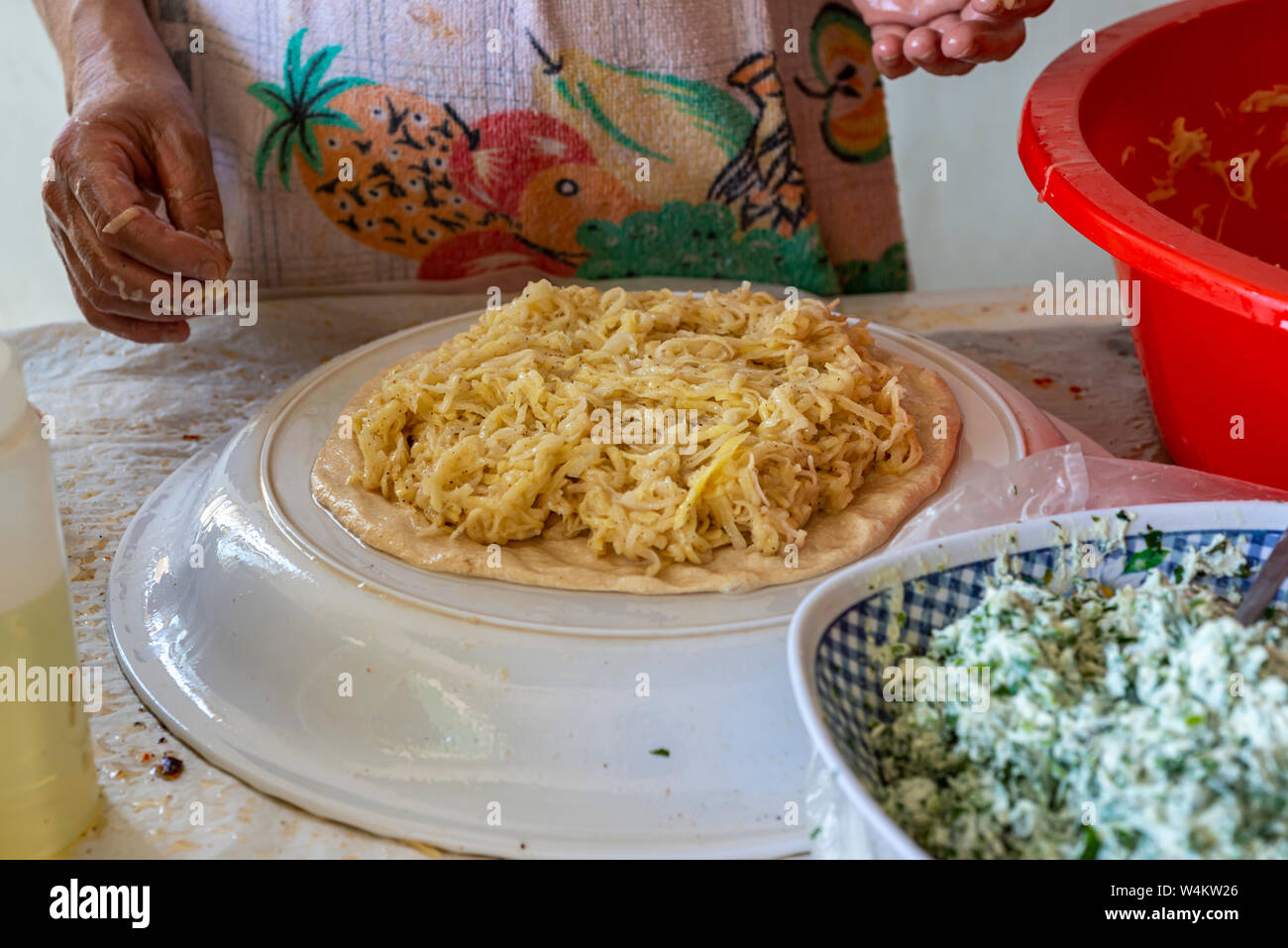 Preparing stuffed pita with potato strings Stock Photo - Alamy