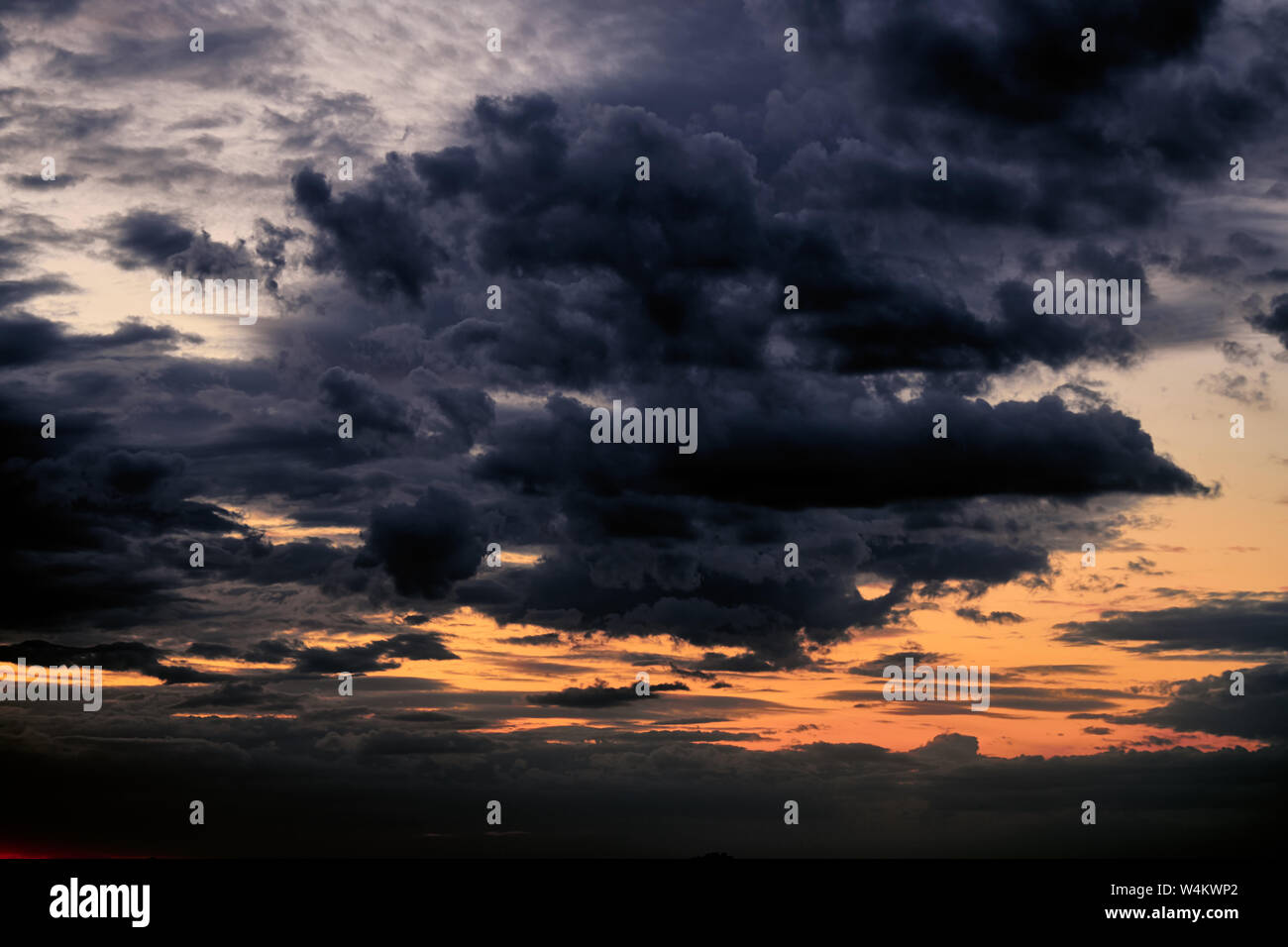 Beautiful sunset - dark sky with clouds and sunlight Stock Photo - Alamy