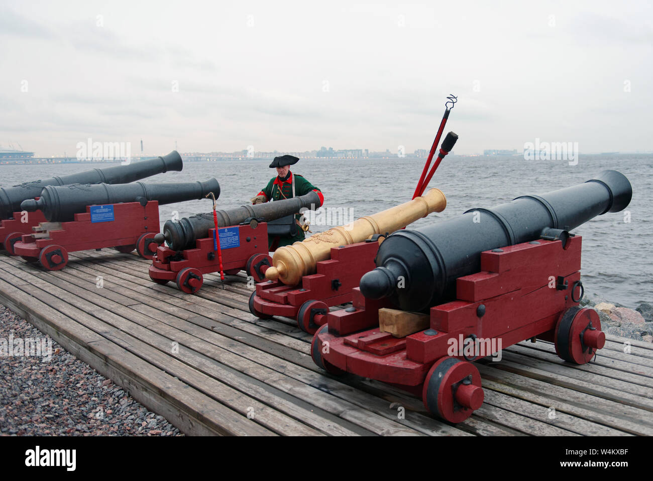 Cannoneer in retro uniform at the cannons that will be installed on the ...