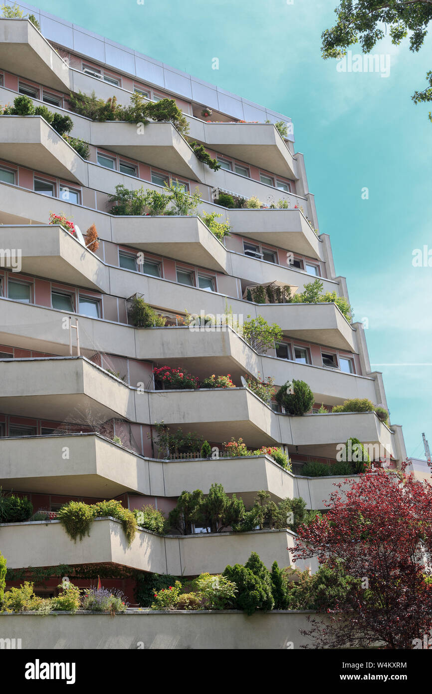 Summer landscape with residential apartment building and balconies with ...