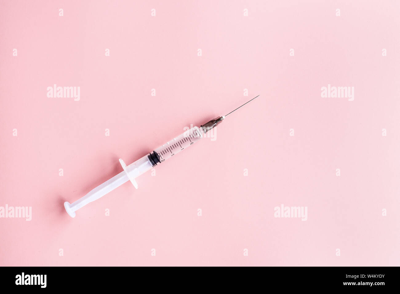 Medical syringe on pink background, give an injection and be healthy ...
